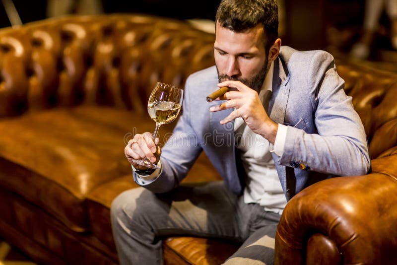 Young Man Tasting White Wine and Smoking Cigar Stock Photo - Image of ...