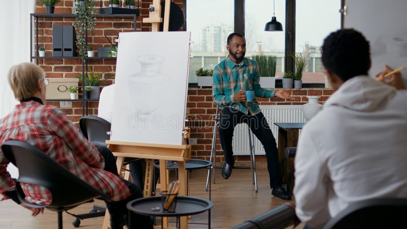 Young Man Teaching Creative People To Draw on Canvas Stock Image ...