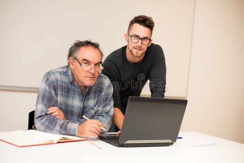 Young Man Teaching Eldery Man of Usage of Computer. Intergenerational ...
