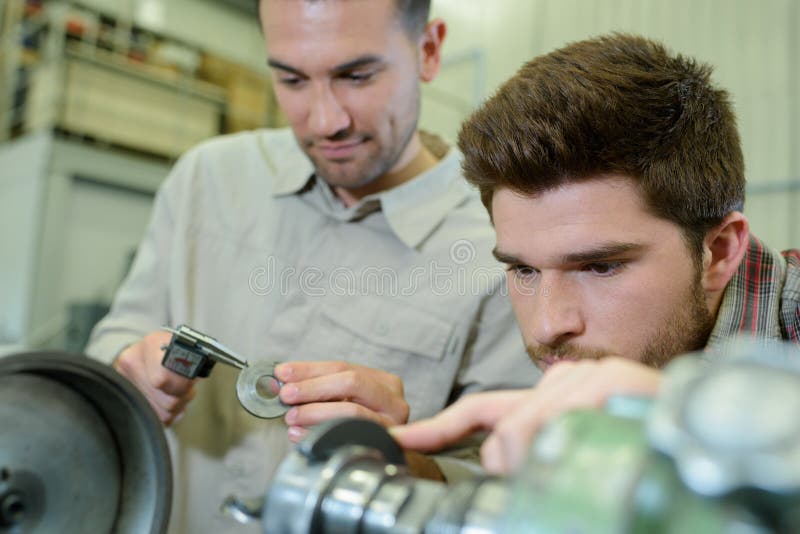 Young Man in Technical Vocational Training with Teacher Stock Photo ...