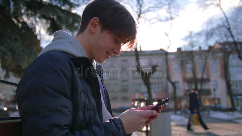 Texting His Way Around. a Handsome Young Man Using His Cellphone on ...