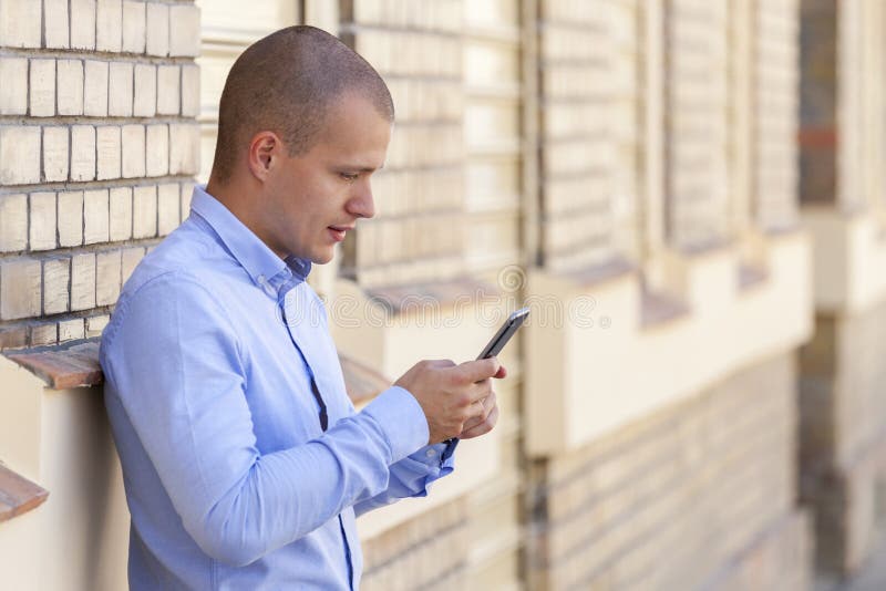 Young Man Texting on a Mobile Phone Stock Photo - Image of looking ...
