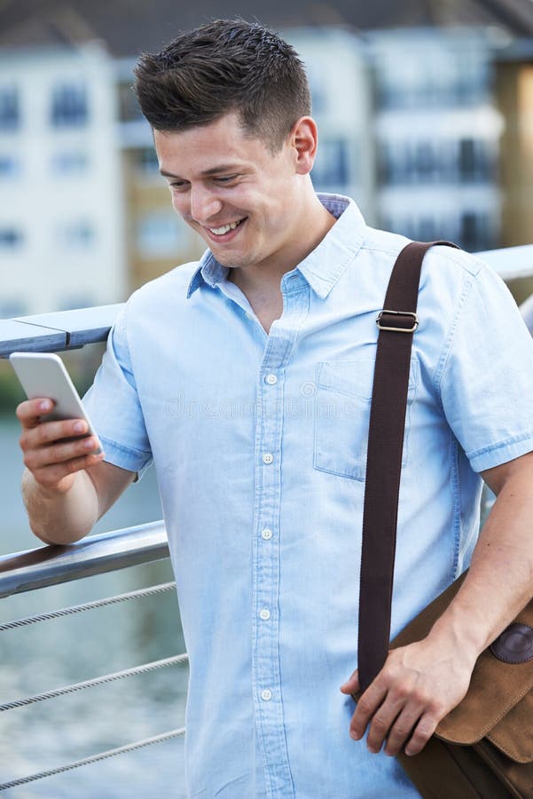 Young Man Texting on Mobile Phone Walking To Work Stock Image - Image ...