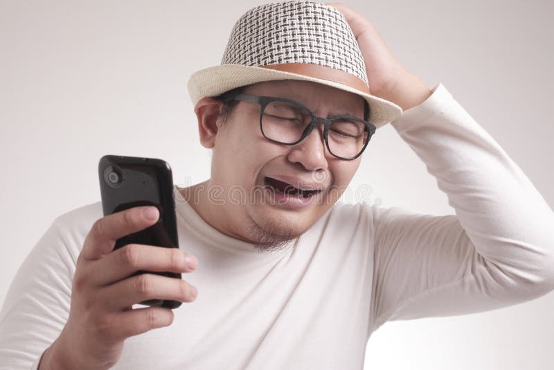 Young Man Texting Reading Chatting On His Phone Sad Crying Stock Image