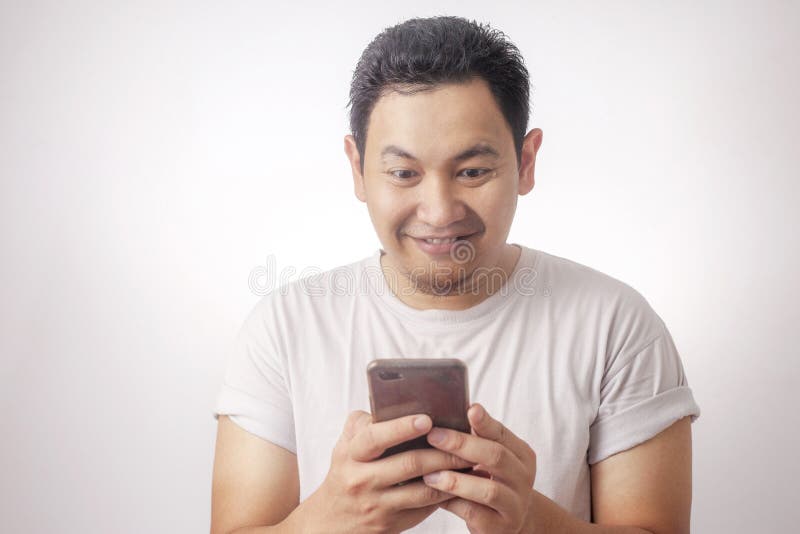 Young Man Texting Reading Chatting on His Phone, Smiling Happy Stock ... Young Man Texting Reading Chatting on His Phone, Smiling Happy Stock ...