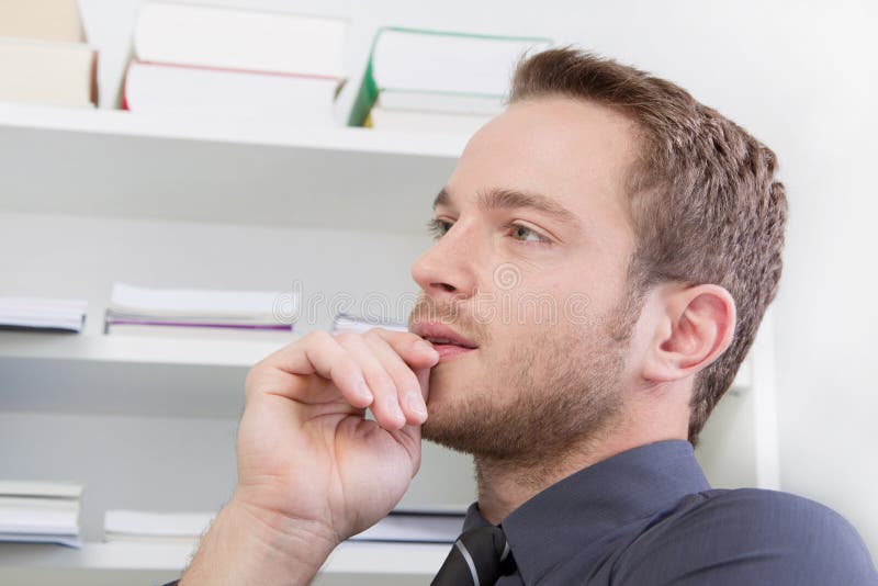 Young Man Thinking at Office. Stock Photo - Image of reflective, cool ...