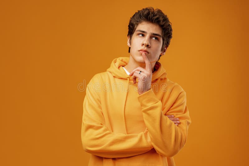 Young Man Thinking about Things on Yellow Background Stock Image ...