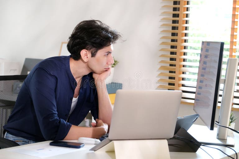 Young Man Thinking while Working with Computer at Home Office, Wrok ...
