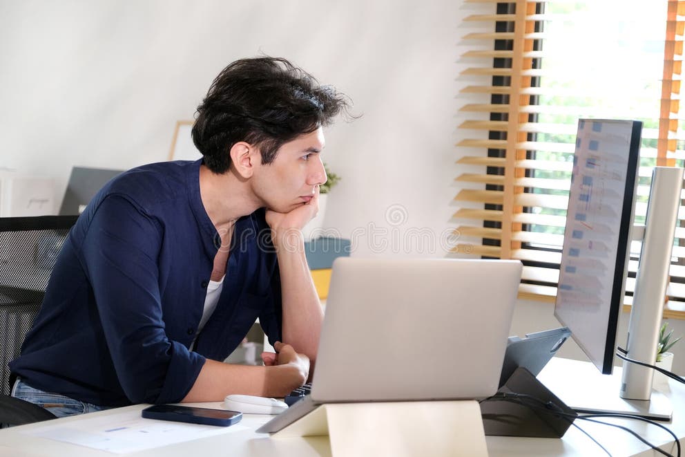 Young Man Thinking while Working with Computer at Home Office, Wrok ...