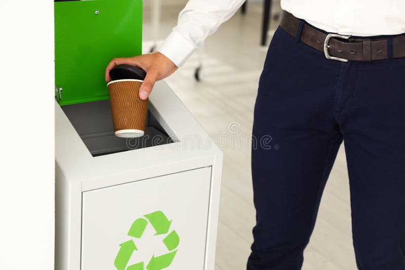 Young Man Throwing Coffee Cup into Recycling Bin in Office Stock Image ...