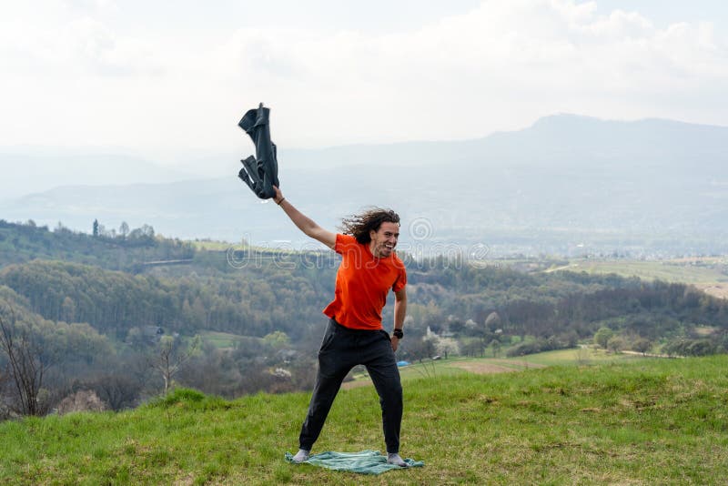 Young Man Throwing a Jacket in the Air on Mountain Stock Image - Image ...