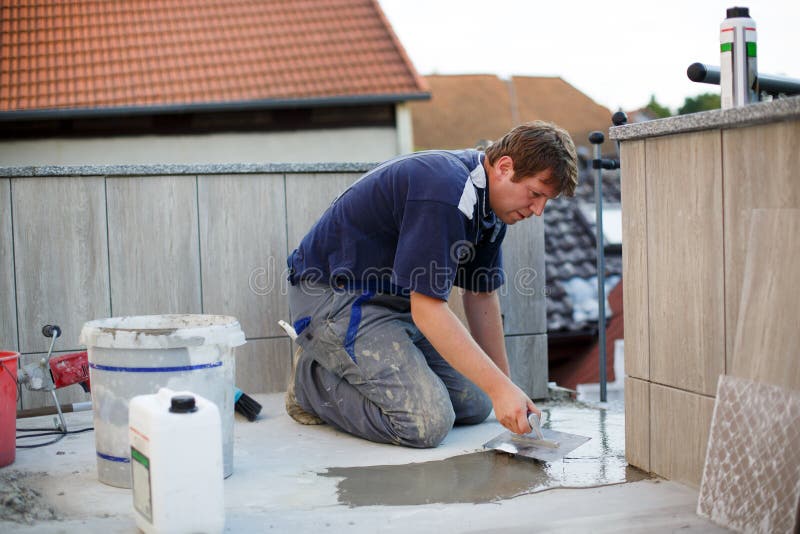 Young Man Tiling on Balkony Ceramic Tiles Stock Photo - Image of tool ...