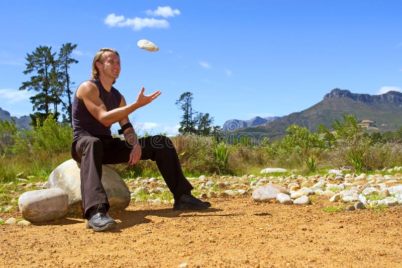 Young Man is Tossing a Rock Stock Image - Image of africa, rest: 3326997