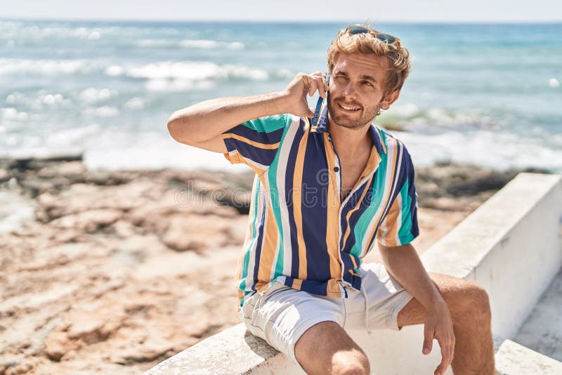 Young Man Tourist Talking on the Smartphone Sitting on Bench at Seaside ...