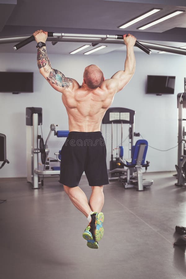 Young Man Training at Gym with Exercises . Young Man Stock Photo ...
