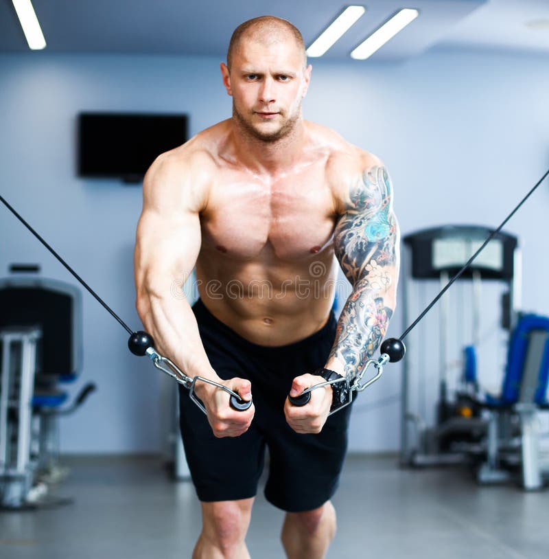 Young Man Training at Gym with Exercises Stock Photo - Image of flexing ...