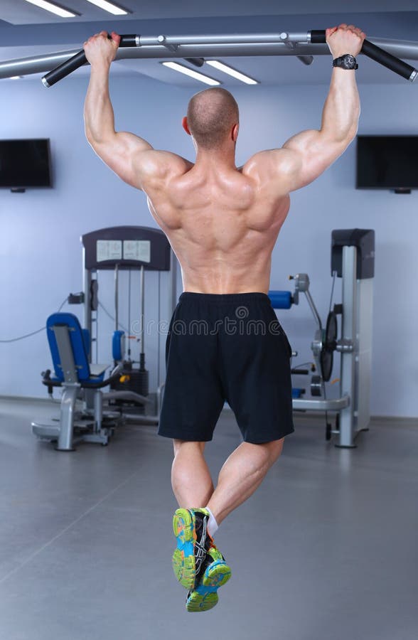 Young Man Training at Gym with Exercises Stock Image - Image of grey ...