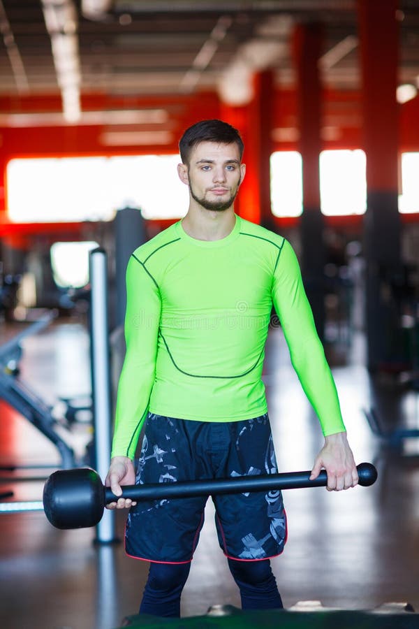 A Young Man is Training in the Gym with a Hammer. Stock Image - Image ...