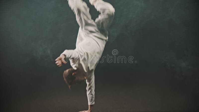 Young Man Training His Dancing in the Studio - Standing on His One Hand ...