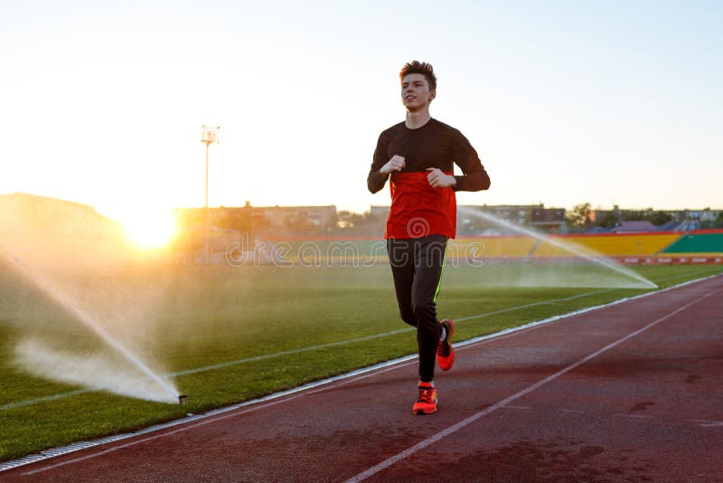 Young Man Is Training At A Sports Stadium Stock Photo - Image of warmth ...