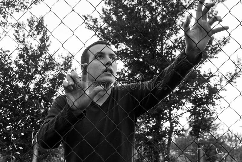 Young Man Trapped Black and White Stock Photo - Image of border, camera ...