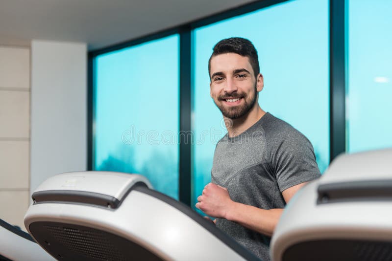 Young Man on Treadmill stock image. Image of exercise - 71101221