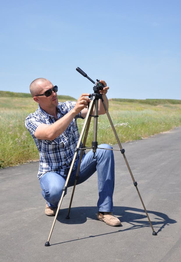 Young man with tripod stock photo. Image of male, professional - 19861902