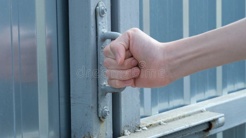 A Young Man Trying To Open a Metal Gate. Stock Footage - Video of ...