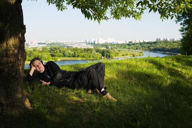 Young Man Under the Tree stock photo. Image of modern - 12566652