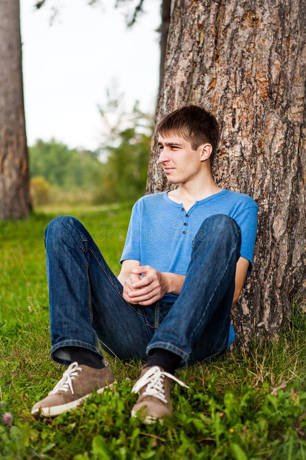 Young Man Under Tree stock photo. Image of loneliness - 101487660