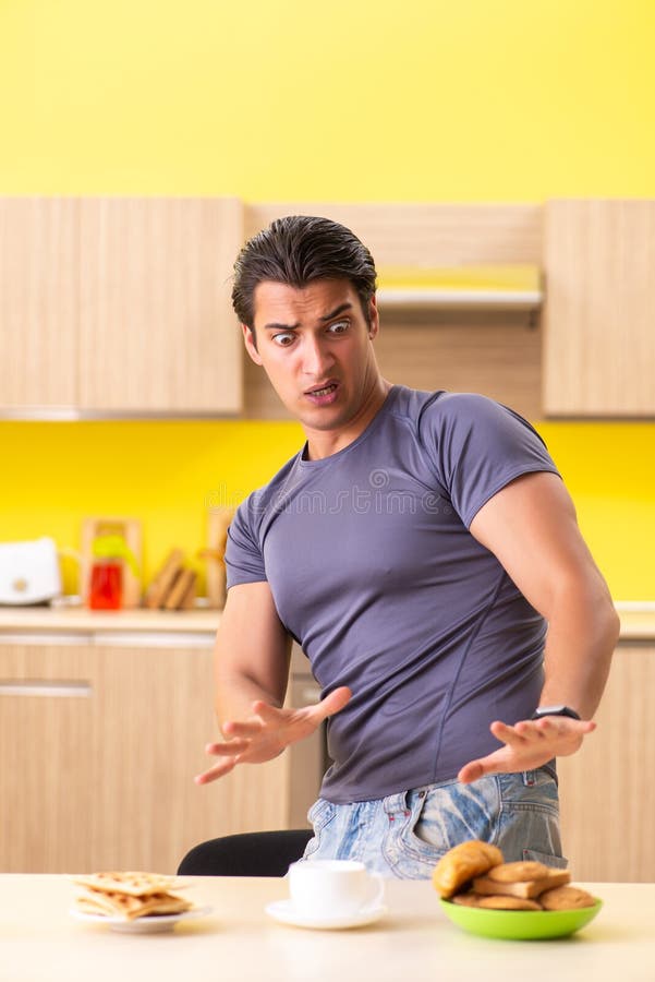 The Young Man in Unhealthy Food Concept Stock Photo - Image of biscuit ...