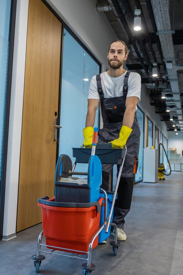 Young Man Uniform Walking Office Corridor Pushing Cart Stock Photos ...