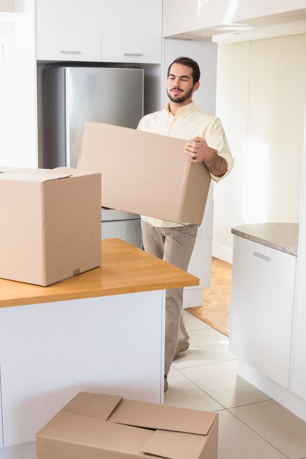 Young Man Unpacking Boxes in Kitchen Stock Image - Image of domestic ...