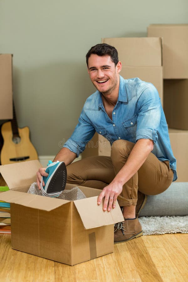 Young Man Unpacking Carton Boxes Stock Image - Image of home, estate ...