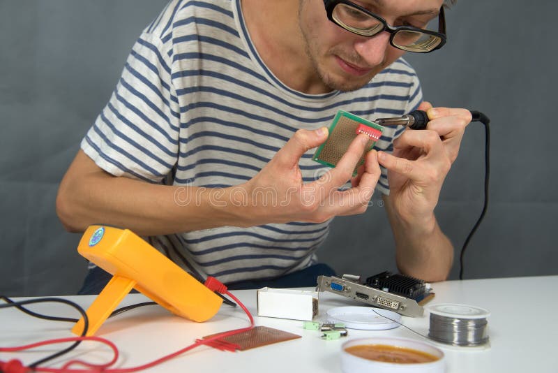 Young Man Iron Soldering Electric Parts Stock Photo - Image of house ...