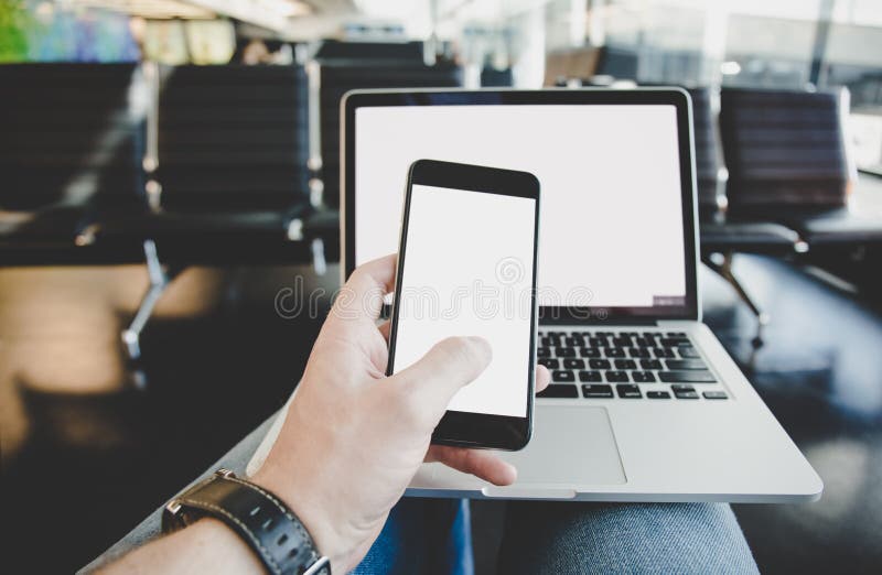 Young Man Use Notebook or Laptop Computer and Phone in the Airport ...