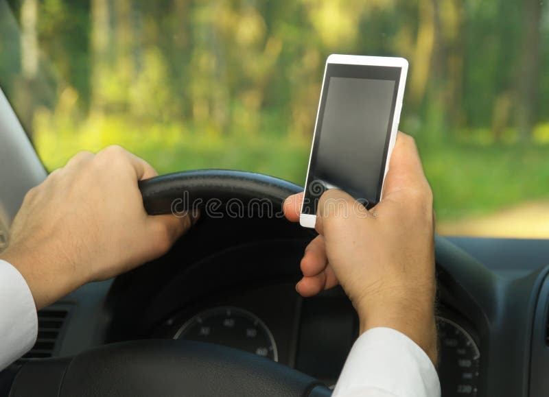 Young Man Uses a Mobile Phone, Driving a Car Stock Image - Image of ...
