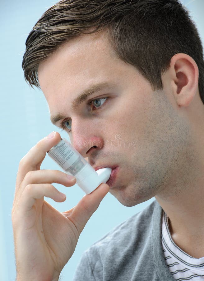 Young Man Using an Asthma Inhaler Stock Photo - Image of adult, inhaler ...