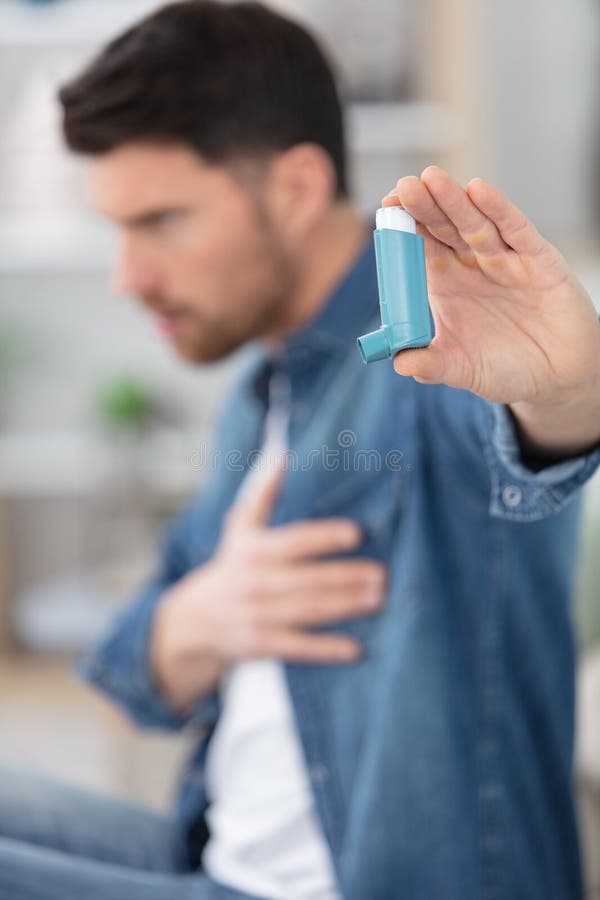 Young Man Using Asthma Inhaler at Home Stock Photo - Image of doctor ...