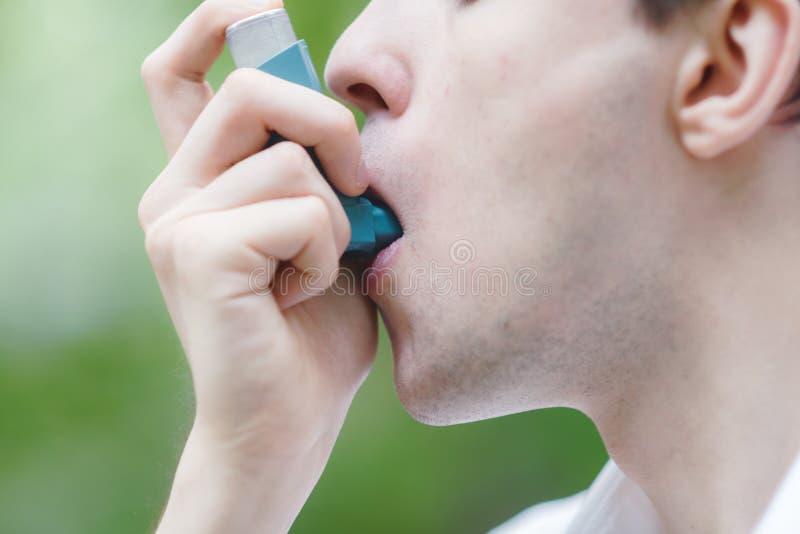 Young Man is Using a Asthma Inhaler Stock Photo - Image of japan ...