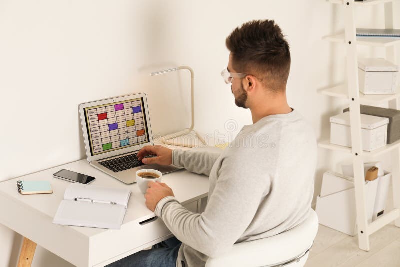 Young Man Using Calendar App on Laptop Stock Photo - Image of agenda ...