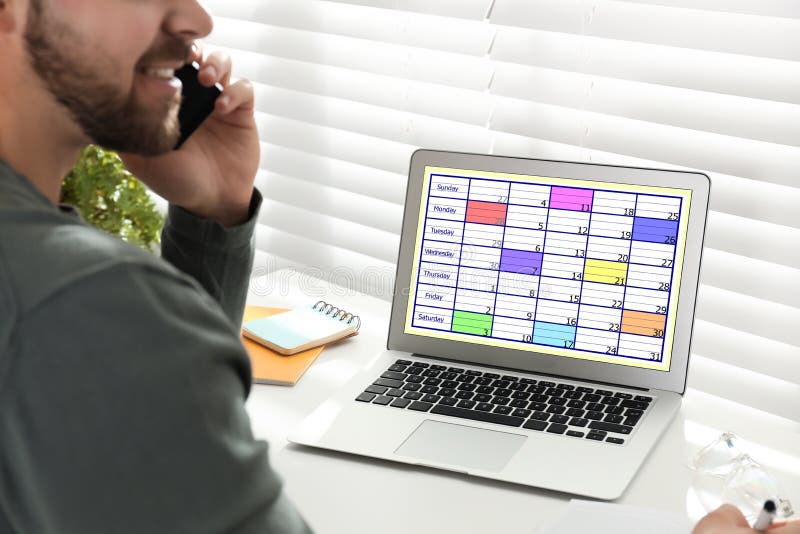 Young Man Using Calendar App on Laptop in Office Stock Photo - Image of ...
