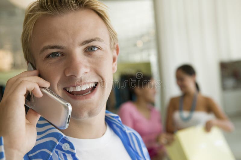 Young Man Using Cell Phone in Clothing Store Portrait Close Up Stock ...