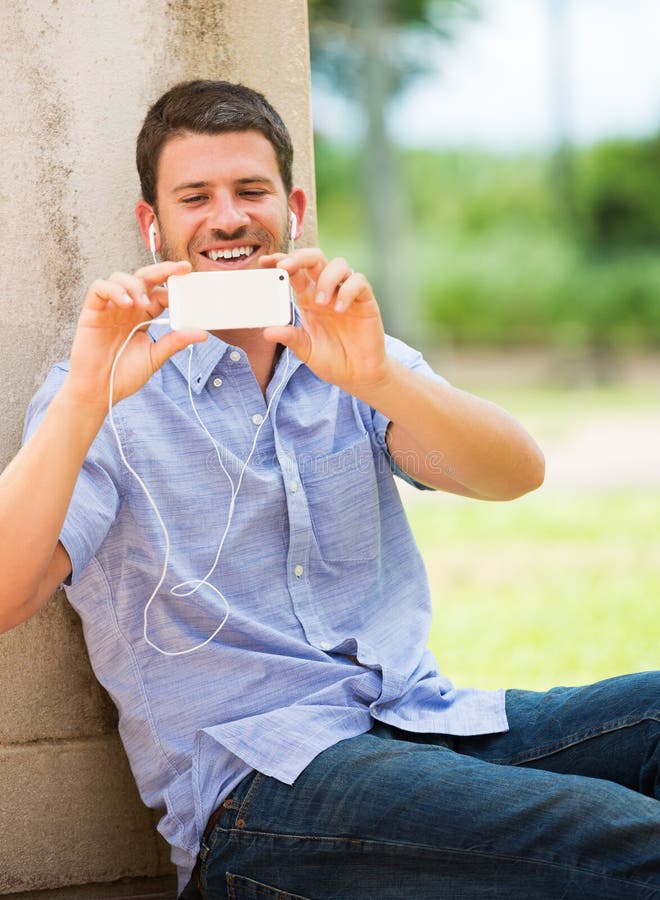 Young man using cell phone stock image. Image of outside - 42018549