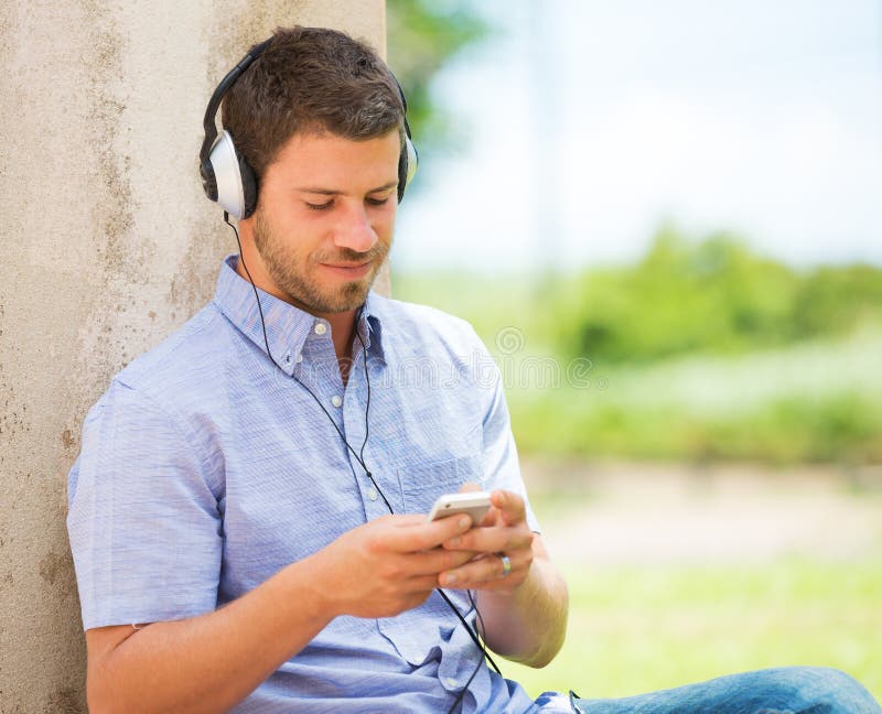 Young man using cell phone stock image. Image of outside - 42018549