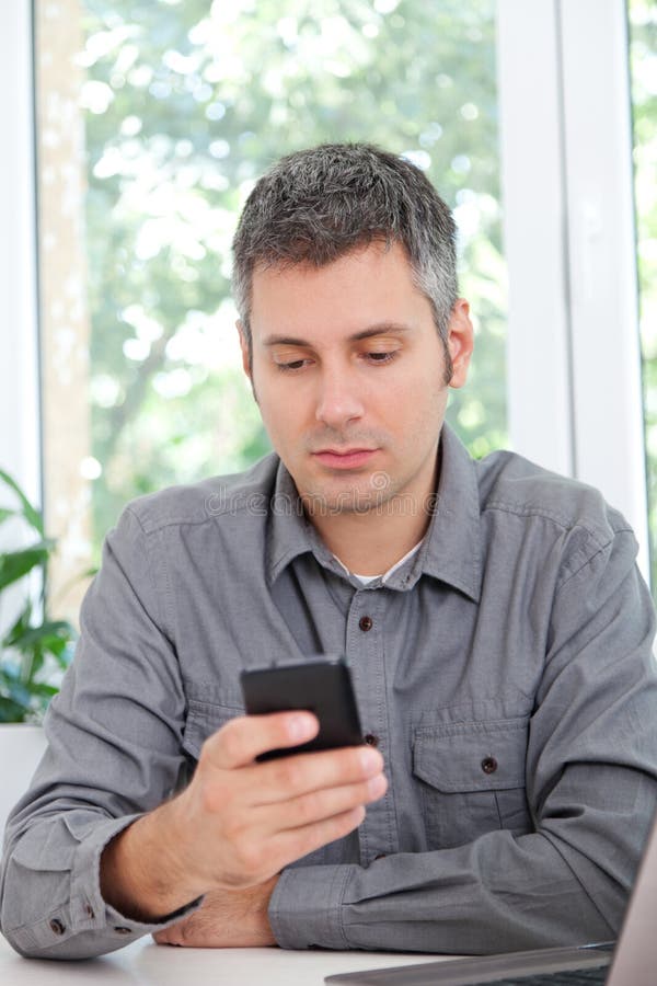 Young man using cell phone stock image. Image of caucasian - 72063917