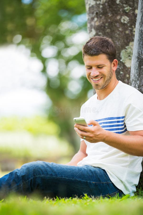 Young man using cell phone stock image. Image of outside - 42018549