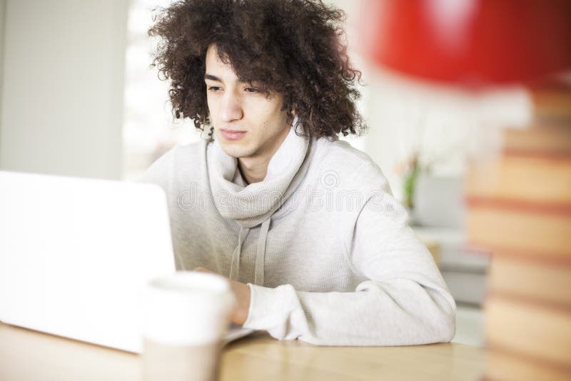 Young man using computer stock photo. Image of male, desk - 65651838