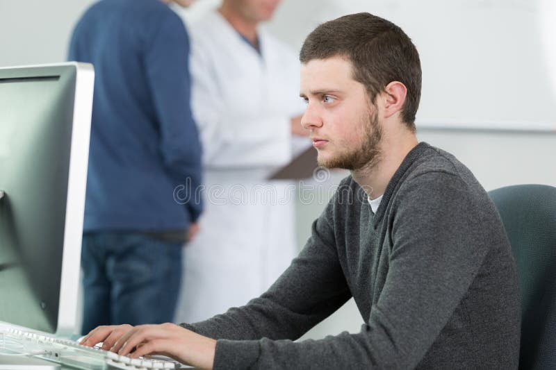Young Man Using Computer in Classroom Stock Image - Image of interior ...