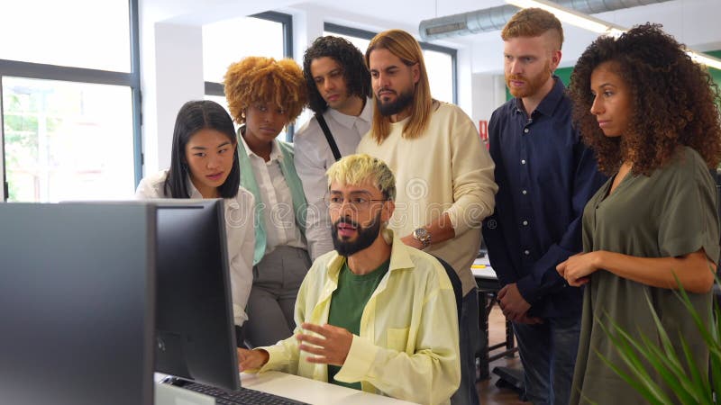 Young Man Using Computer To Explain Data To Coworkers Stock Footage ...